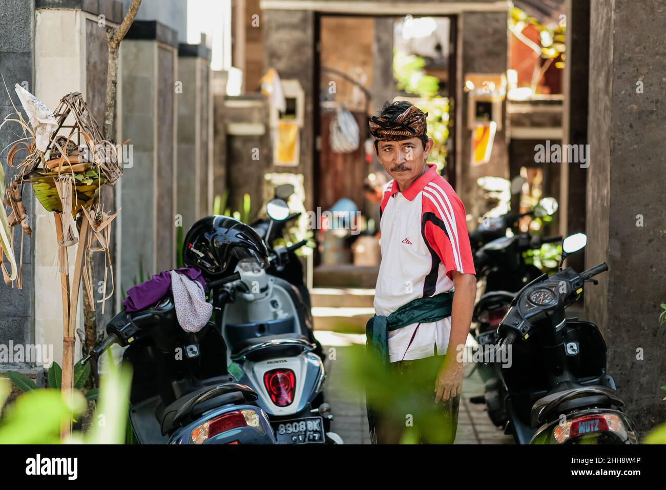 BALI, INDONESIA - MARCH 2, 2014: Balinese man standing next to his ...