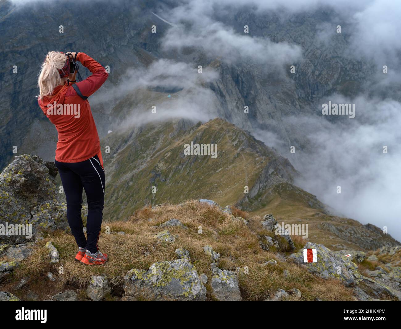 Nature photographer with digital camera trekking in the Transylvanian ...