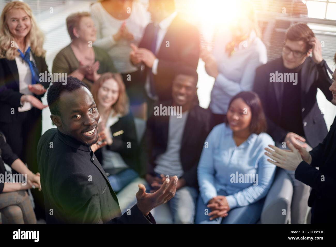 close up. international team applauding their colleague . the concept ...