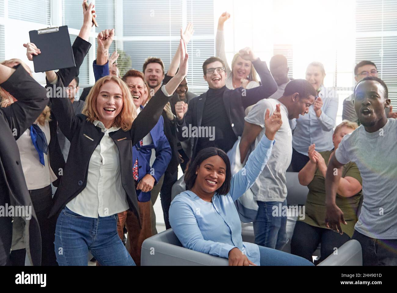 Happy multi ethnic co-workers celebrating a victory in the office Stock ...