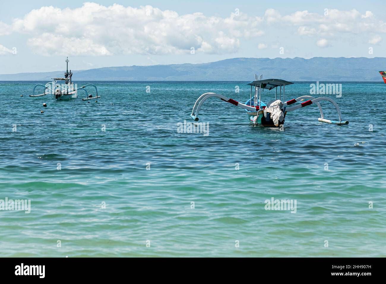 Outrigger boats floating on water, Bali, Indonesia Stock Photo - Alamy