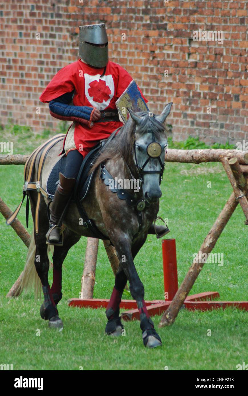 A medieval knight in a helmet, riding a horse Stock Photo - Alamy