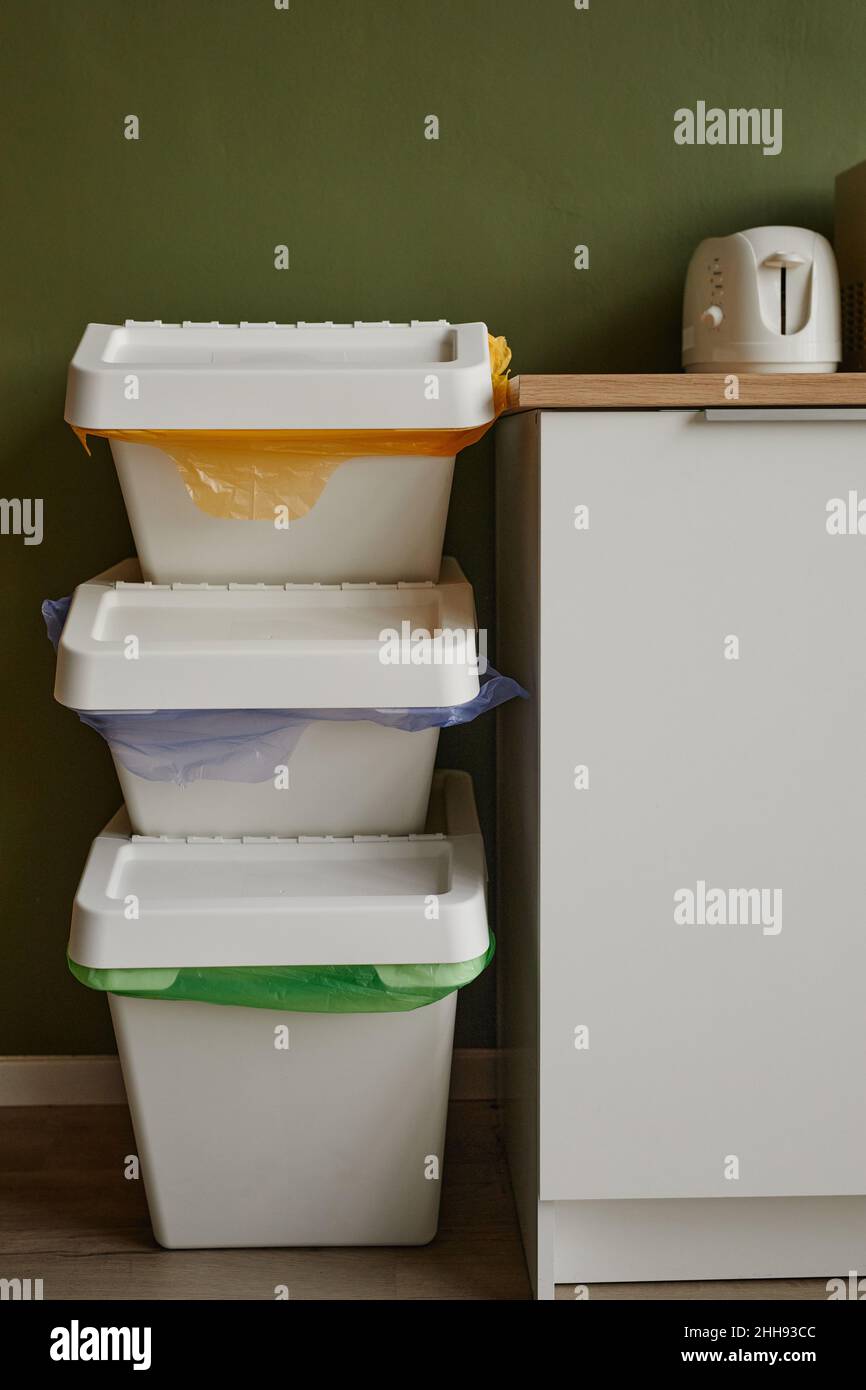 Vertical background image of three waste sorting containers stacked in ...