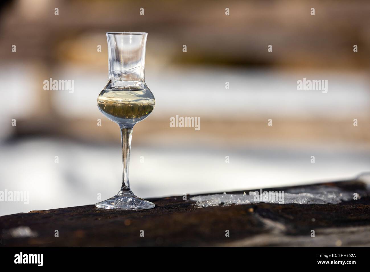 Bokeh picture of a flavored Grappa (Schnapps) glass in Cortina d ...