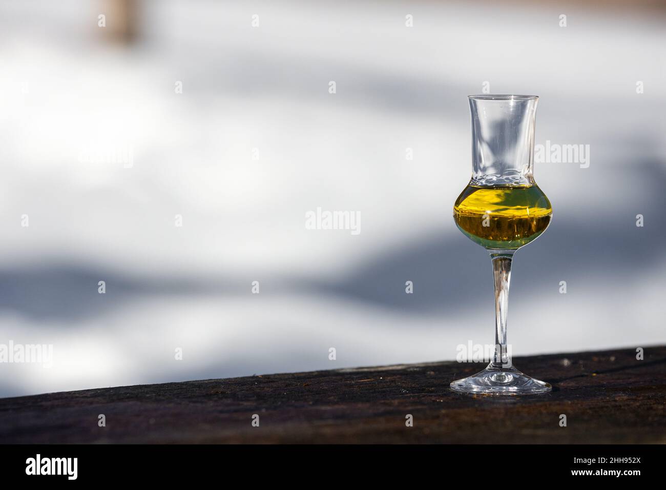Bokeh picture of a flavored Grappa (Schnapps) glass in Cortina d ...