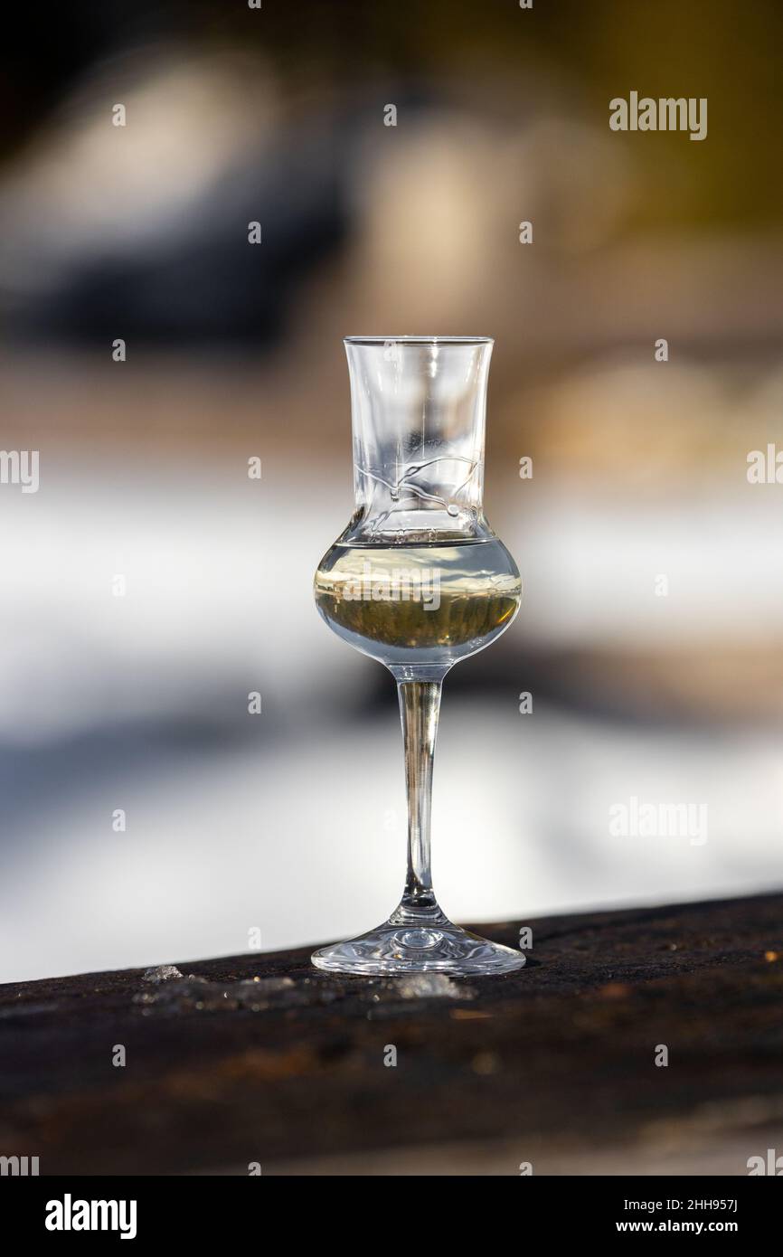 Bokeh picture of a flavored Grappa (Schnapps) glass in Cortina d ...