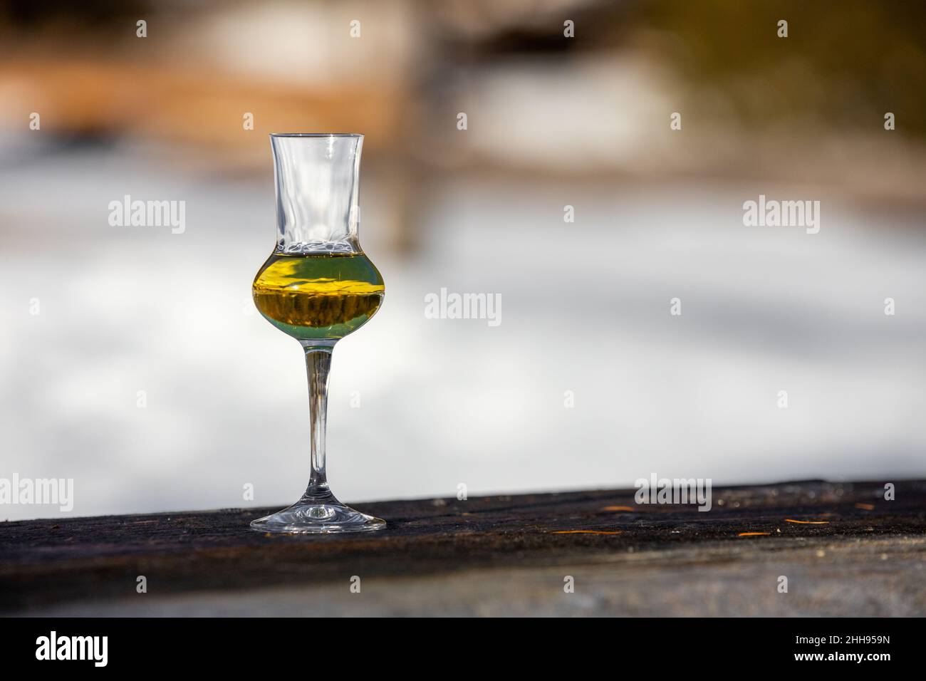 Bokeh picture of a flavored Grappa (Schnapps) glass in Cortina d ...