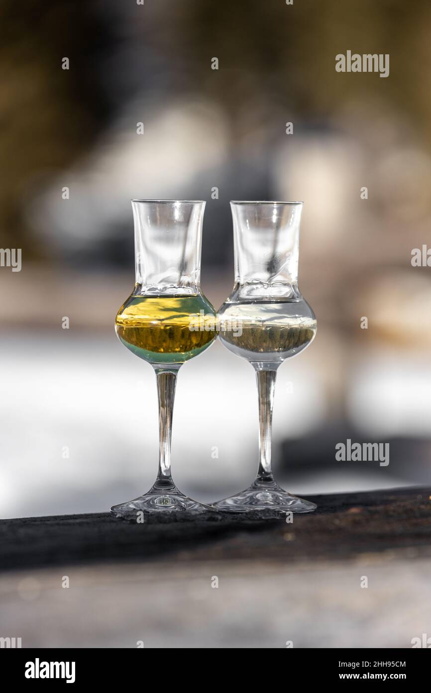 Bokeh picture of two flavored Grappa (Schnapps) glass in Cortina d ...