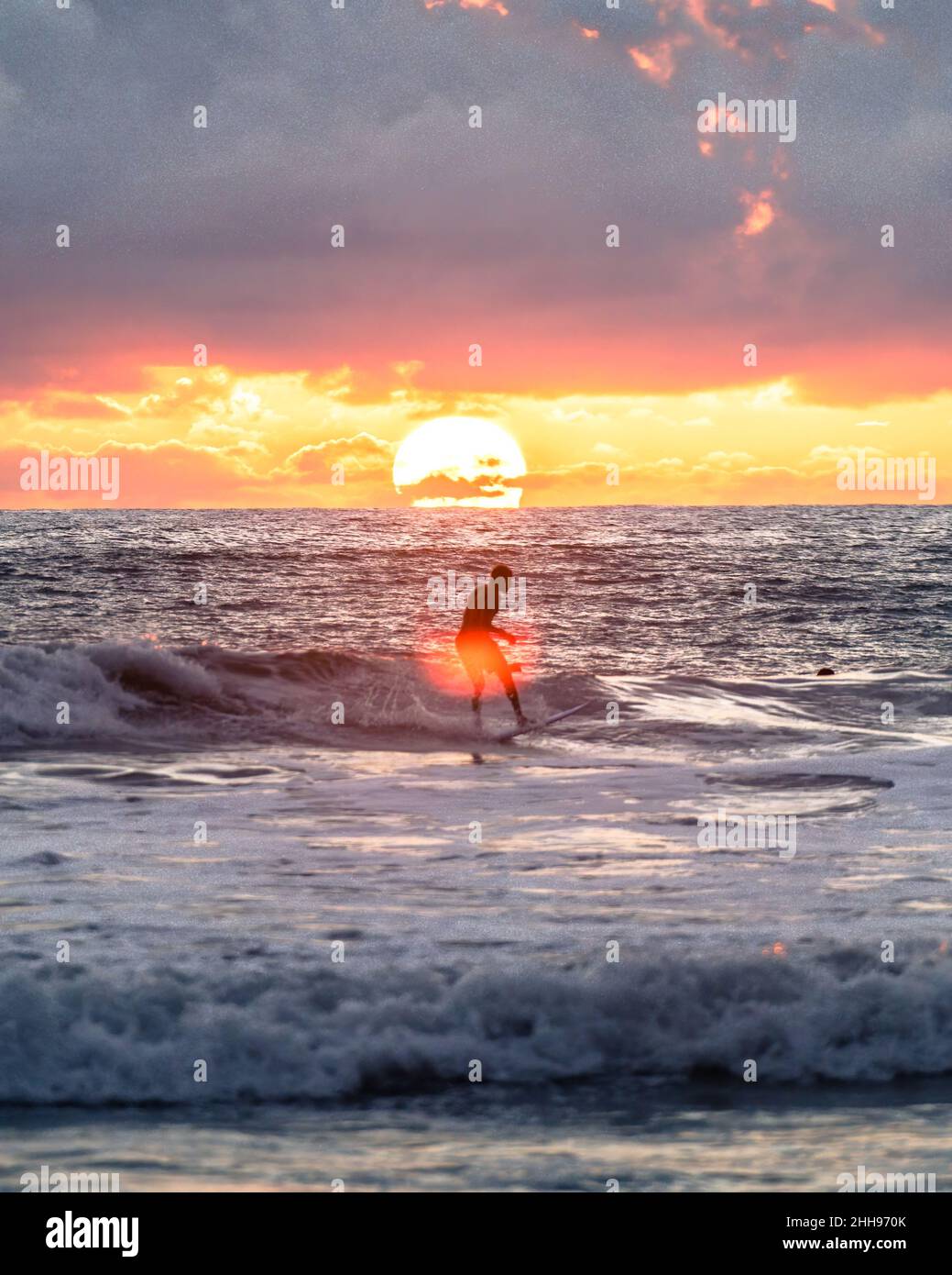 Surfers and Sunset Stock Photo - Alamy
