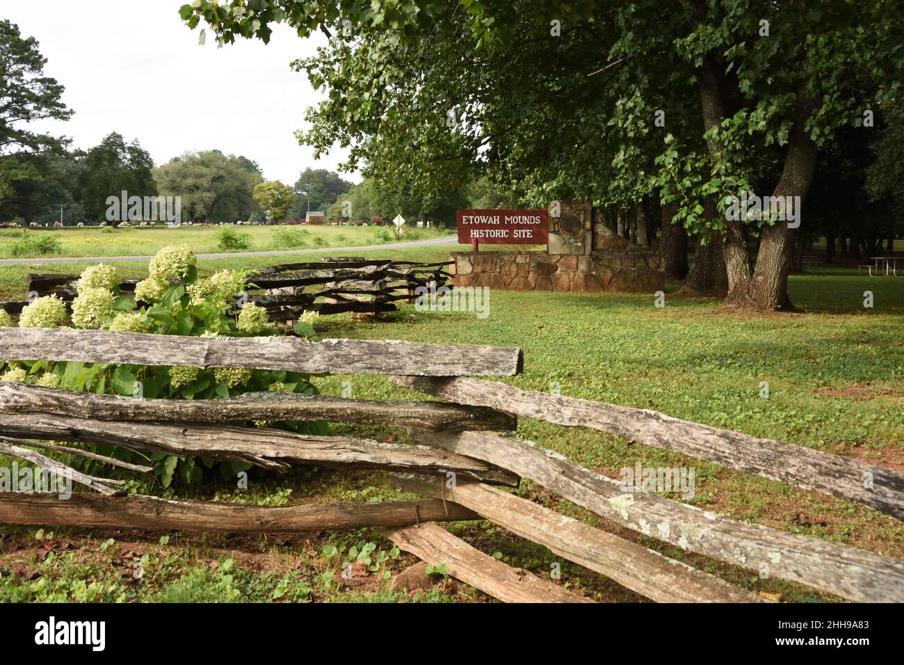 Beautiful landscape with wood fence in the foreground at Etowah Mounds ...