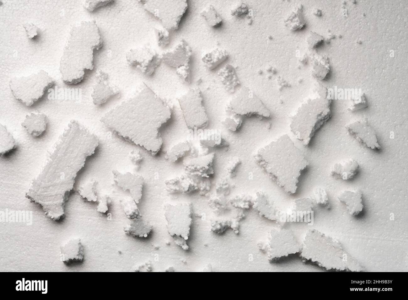Broken pieces of white styrofoam on the sheet of white styrofoam Stock ...
