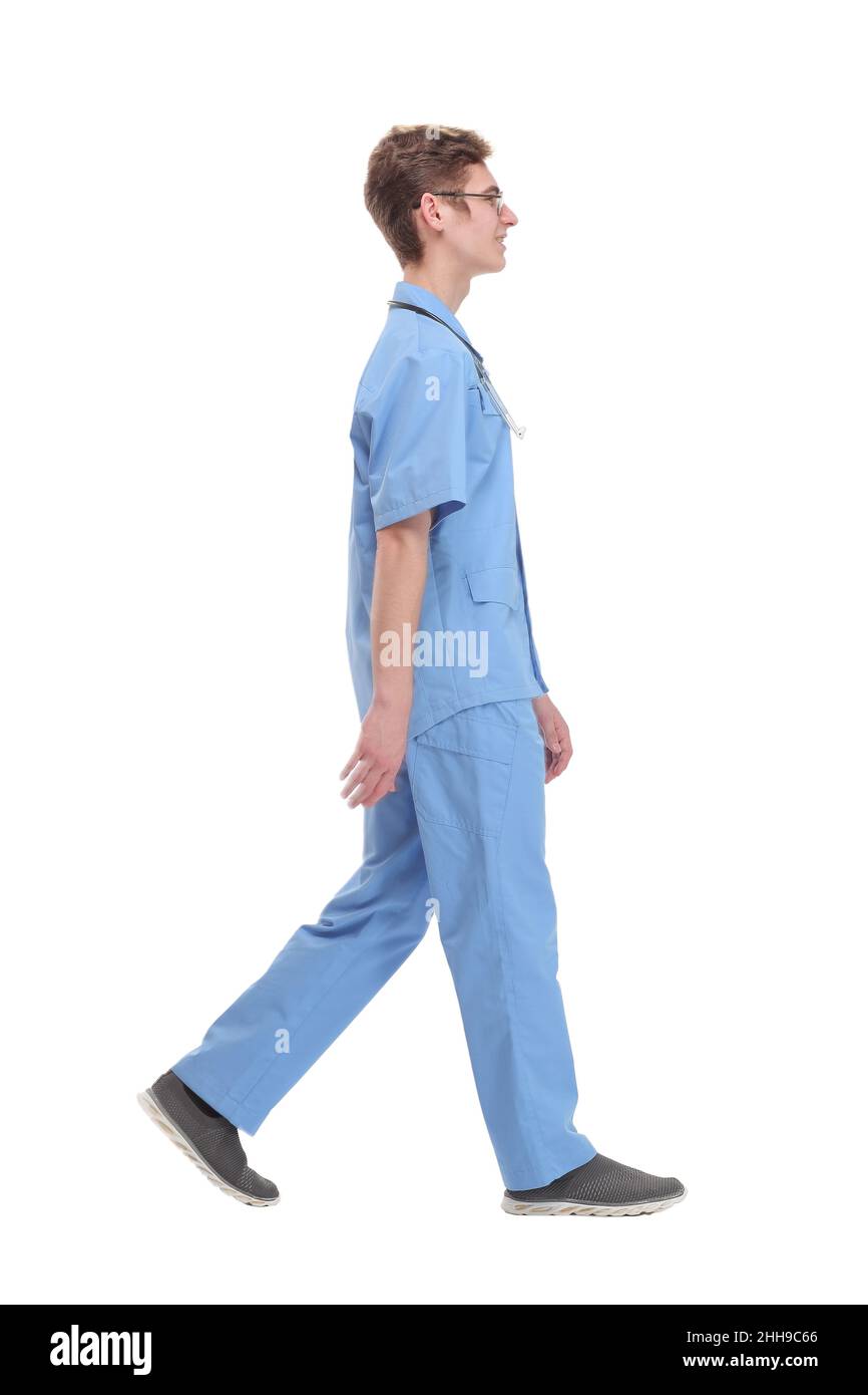 Full length studio shot of walking young male doctor with stethoscope ...