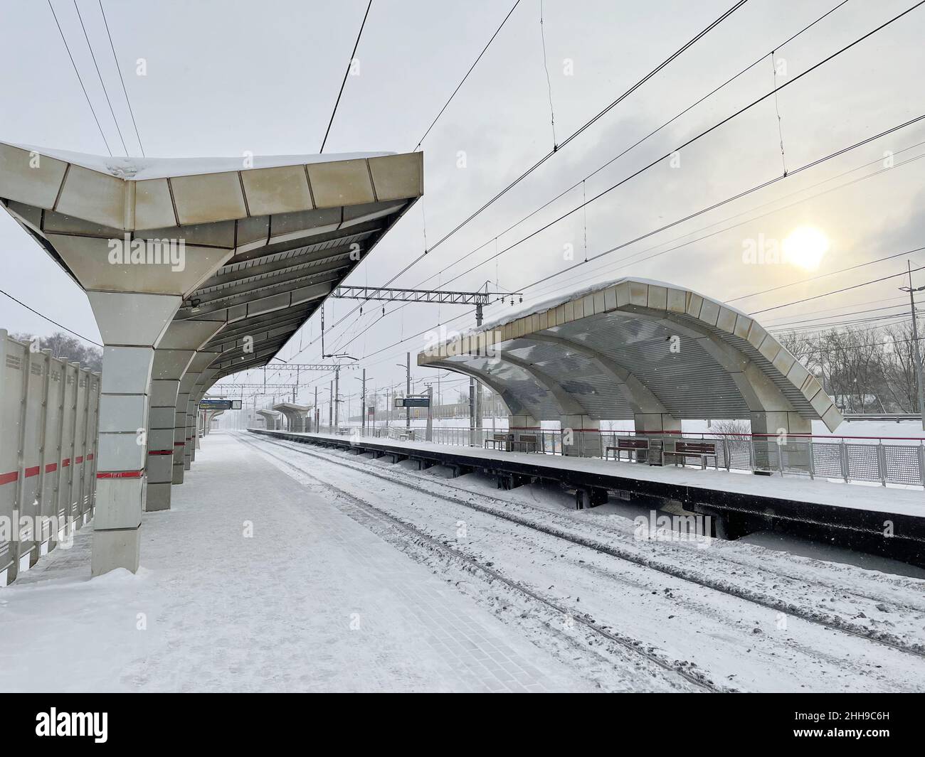 Empty railway platform without passengers in winter at the sunset ...