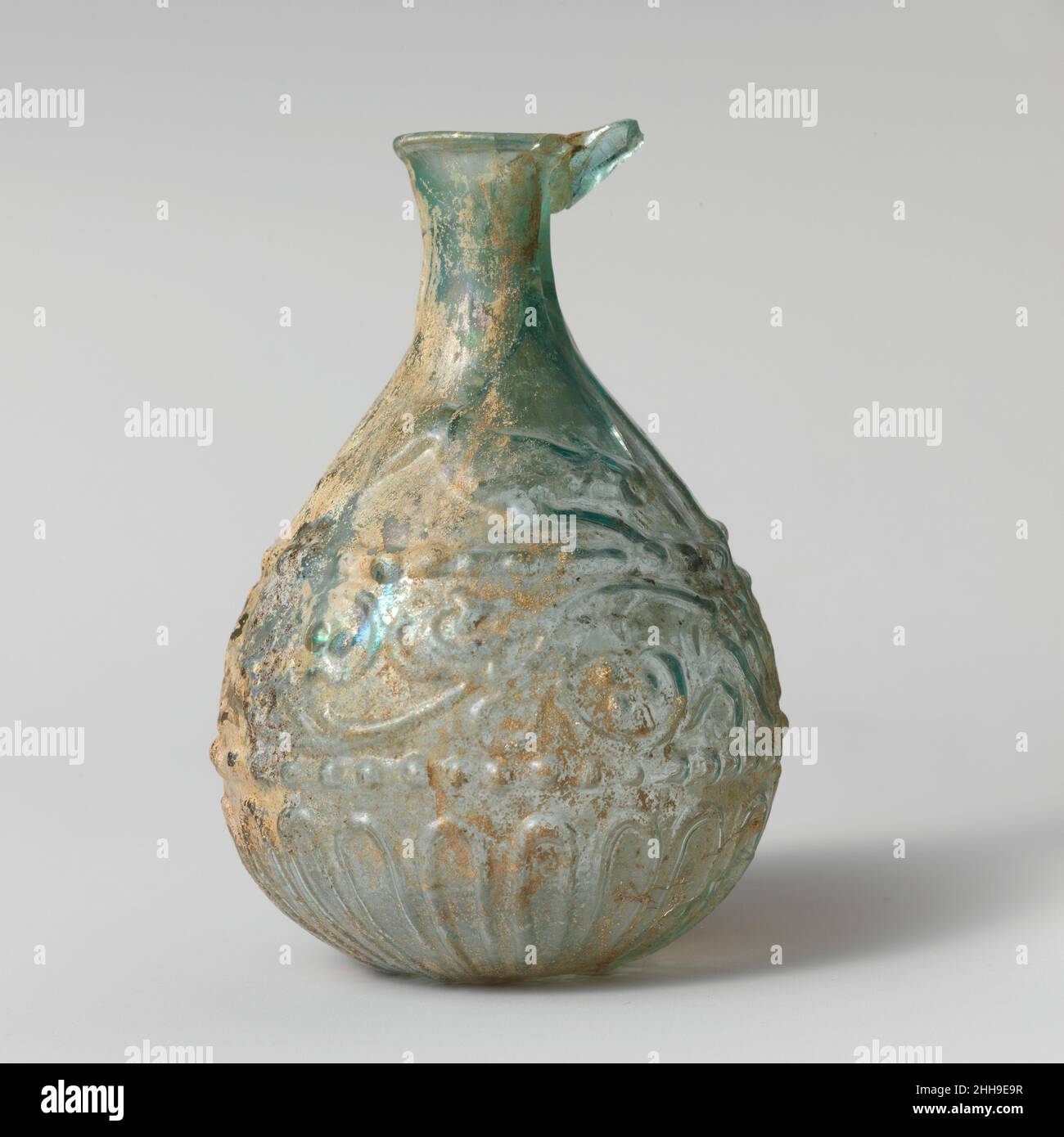Glass hunt-and-scroll bottle 1st century A.D. Roman Translucent blue ...