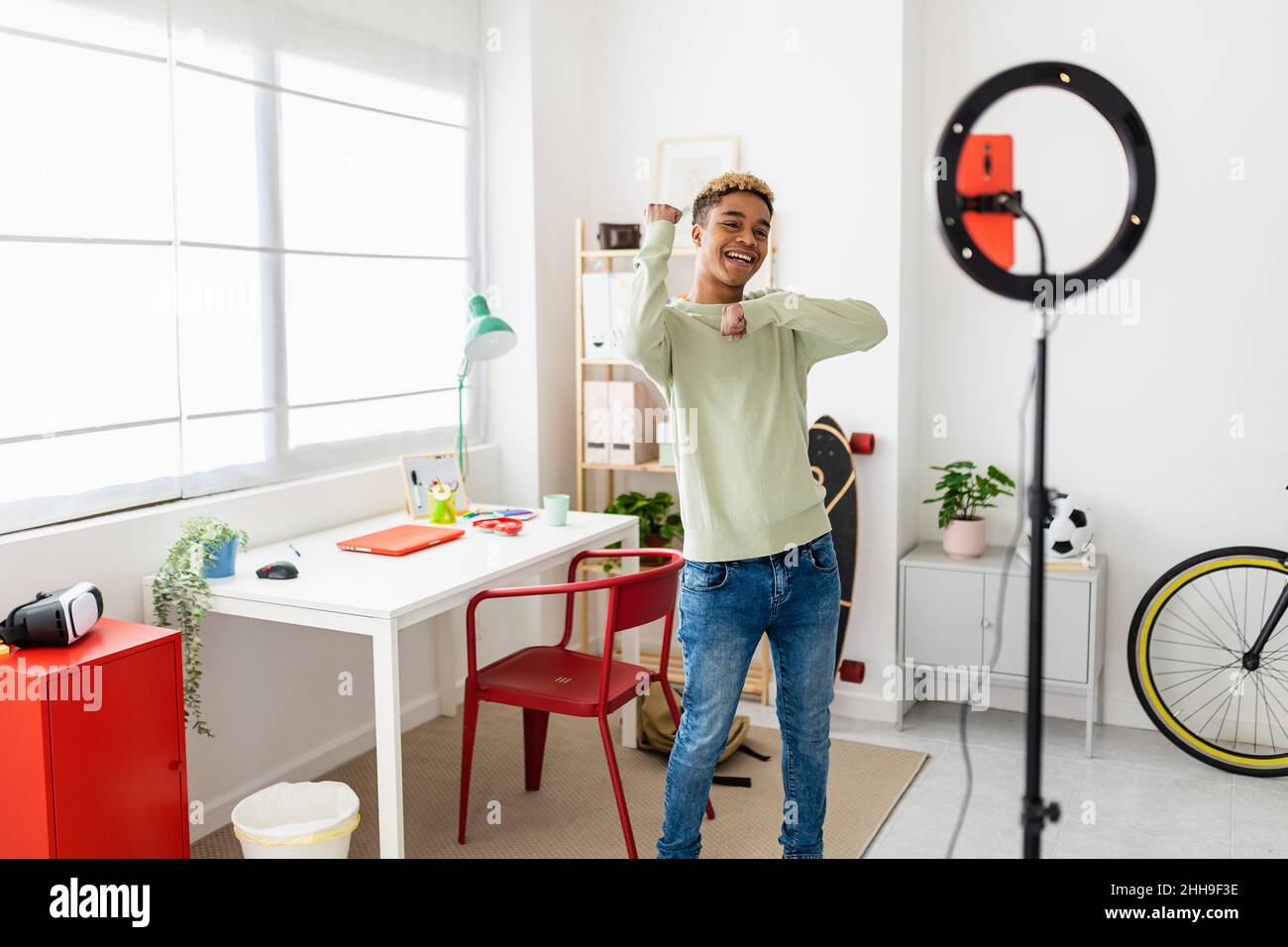 Young man recording dance video tutorial for social media with phone in ...