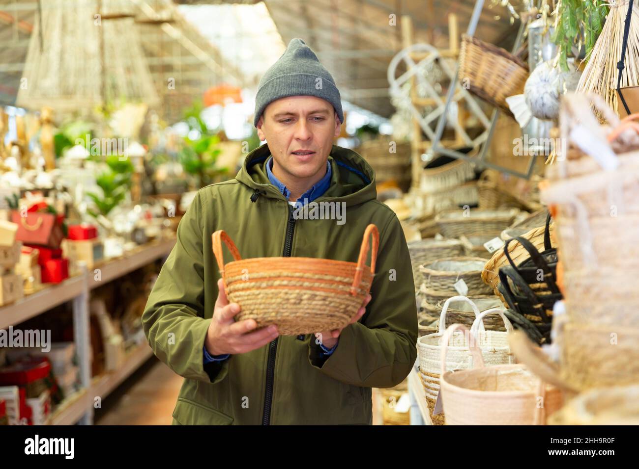 Man buying wicker basket in household goods store Stock Photo - Alamy