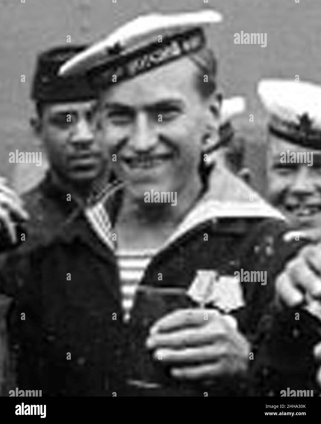 Smiling USSR sailor drinking beer from ''olive drab'' color beer cans ...