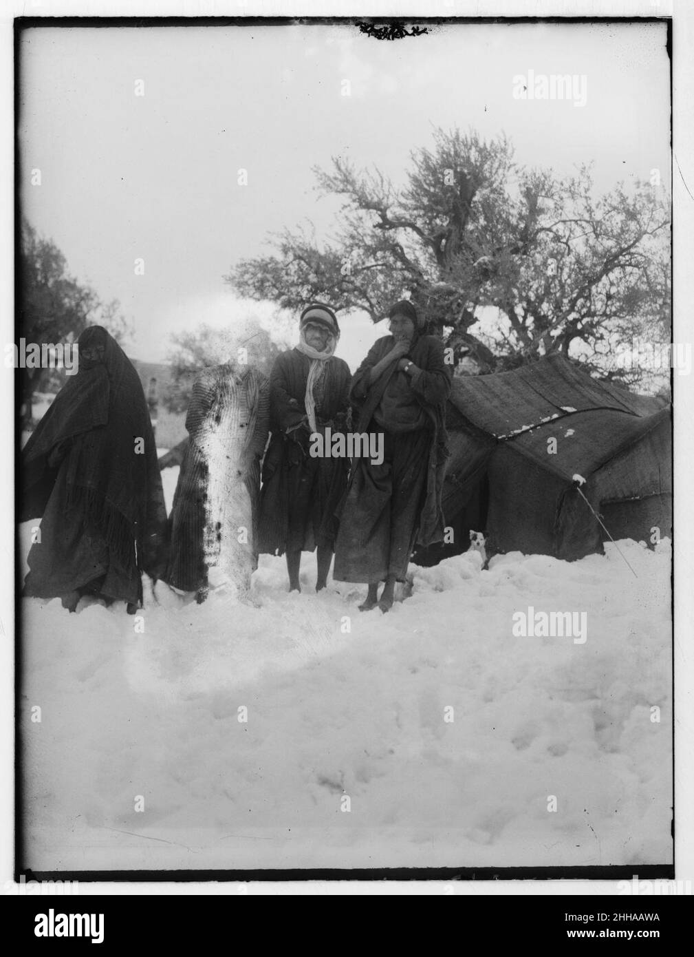 Snow in Jerusalem, 1921. Arab women in snow near tent Stock Photo - Alamy