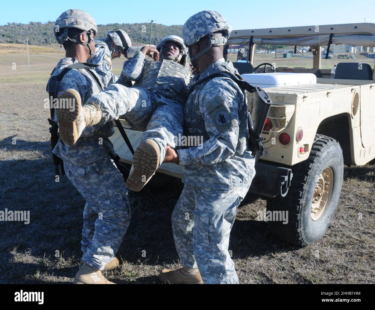 Soldiers from the 525th Military Police Battalion load an injured ...
