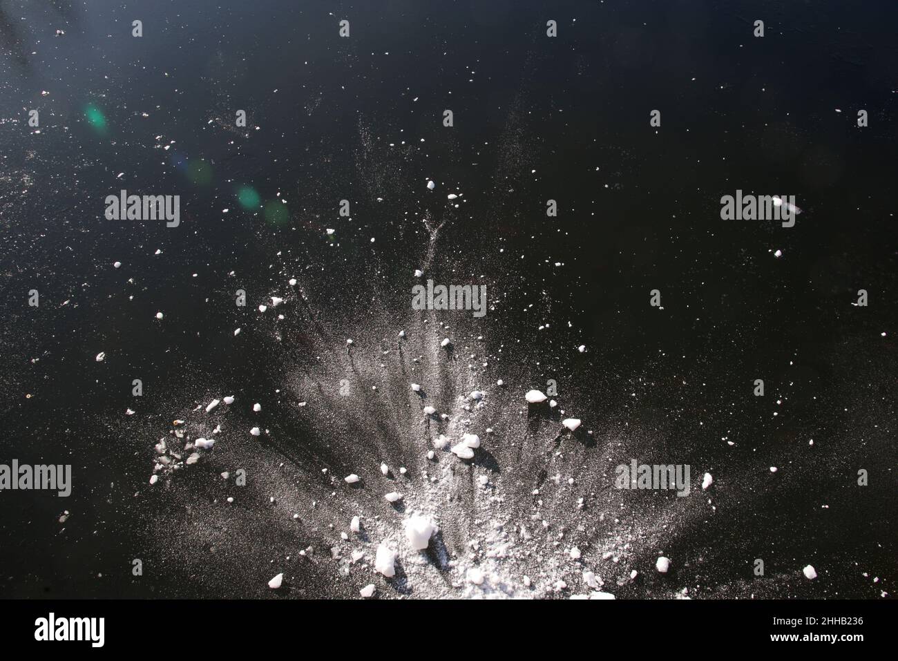 Winter abstract background. Snow hit the ice with a mighty splash. The ...