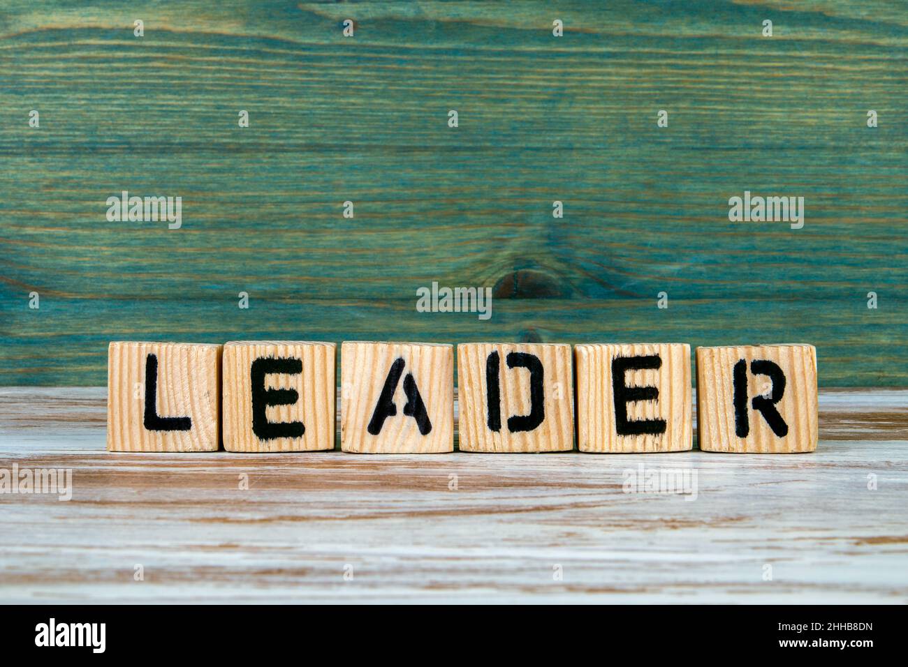 Leader. Word from wooden letters on a white and green background Stock ...