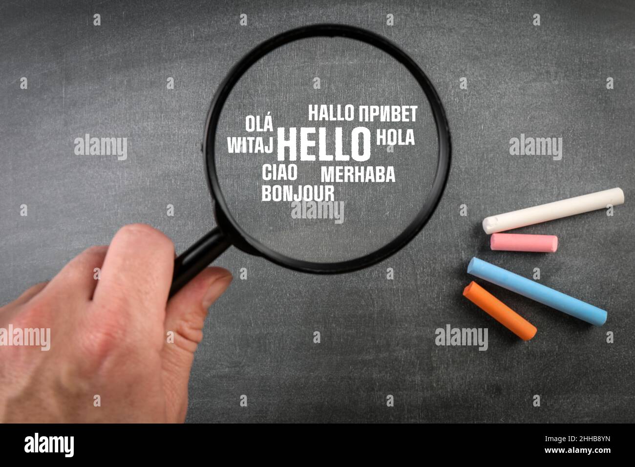 Hello. Text in different world languages. Magnifying glass on a dark ...