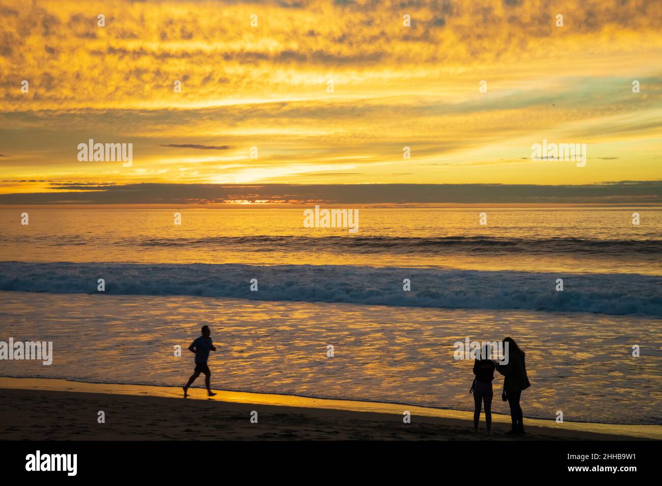 People enjoying the beach during sunset Stock Photo - Alamy