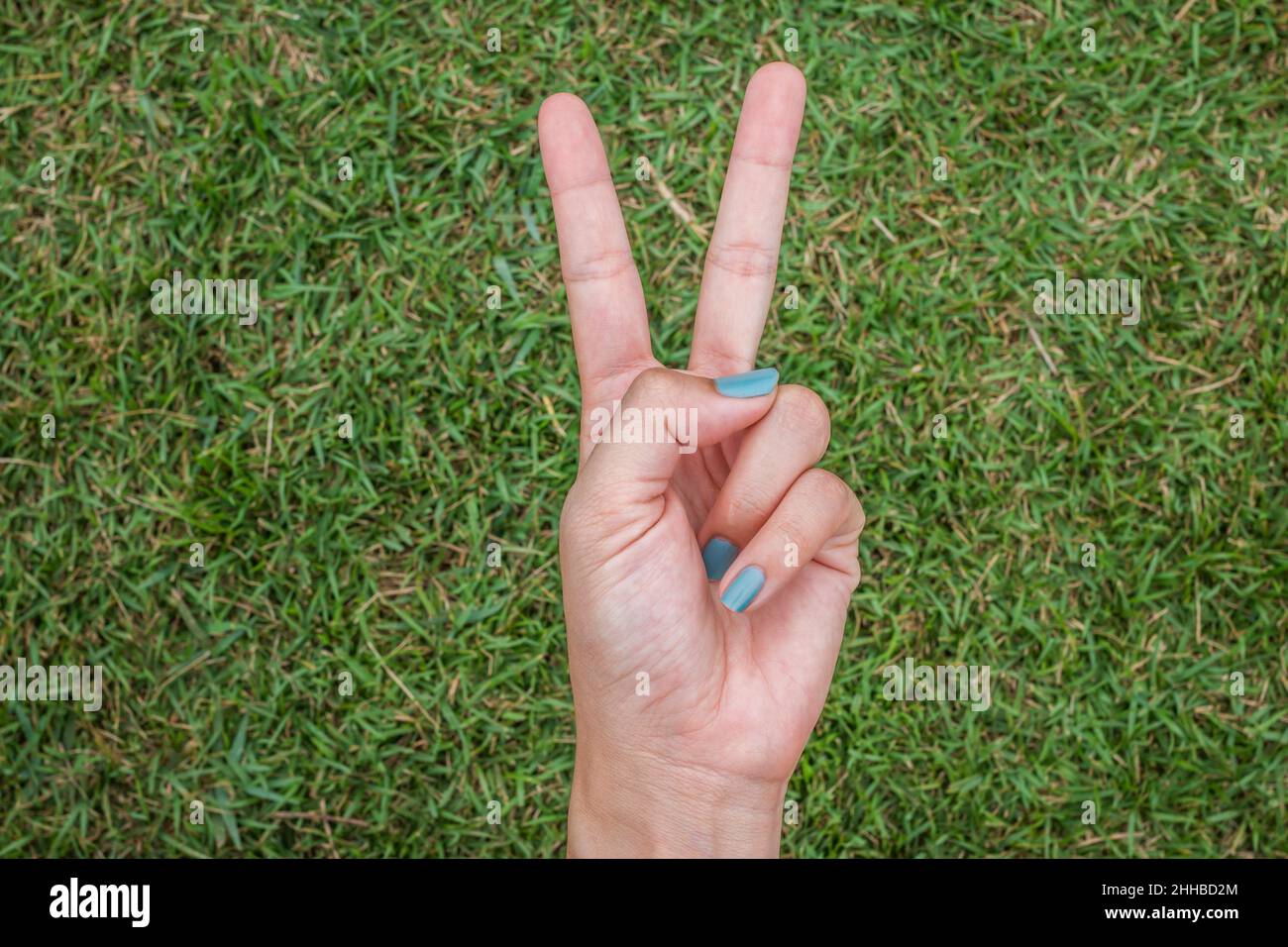 Woman hand holding up the peace sign or number two with two fingers on ...