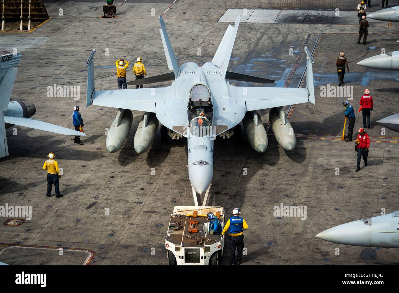 220121-N-EE352-1126 PHILIPPINE SEA (Jan. 21, 2022) Sailors taxi an F/A-18E Super Hornet ...