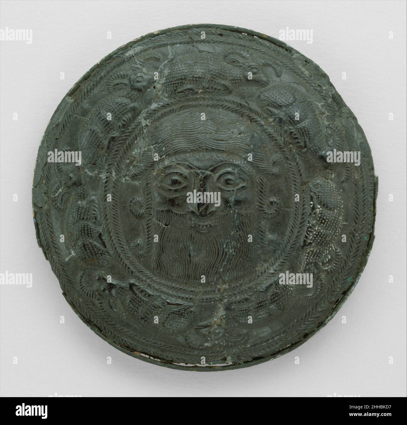 Roundel with head of a "hero" surrounded by caprids ca. 14th–13th ...