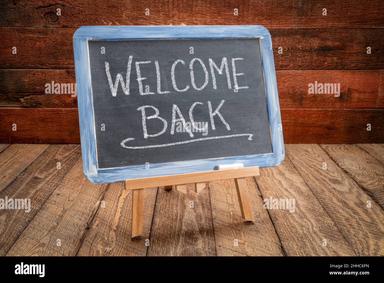 welcome back - white chalk handwriting on a slate blackboard, easel ...