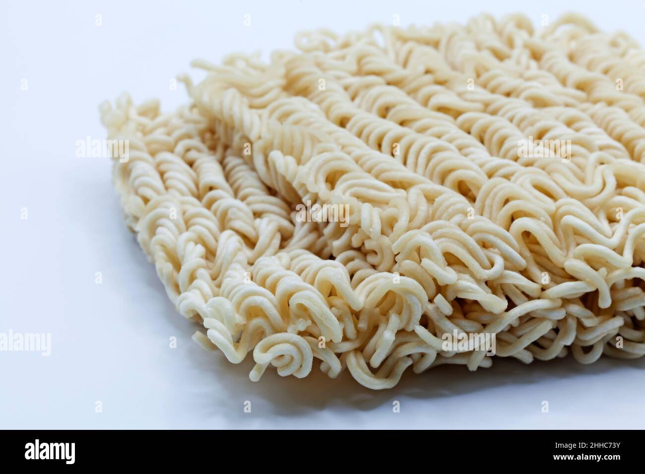 uncooked noodles on white background Stock Photo - Alamy