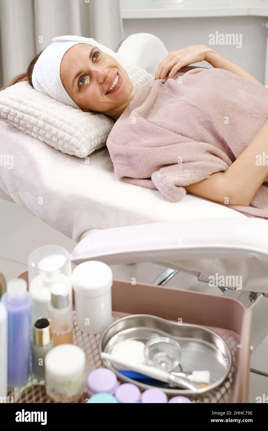 Happy woman at cosmetologist, before care and treatment procedure in ...