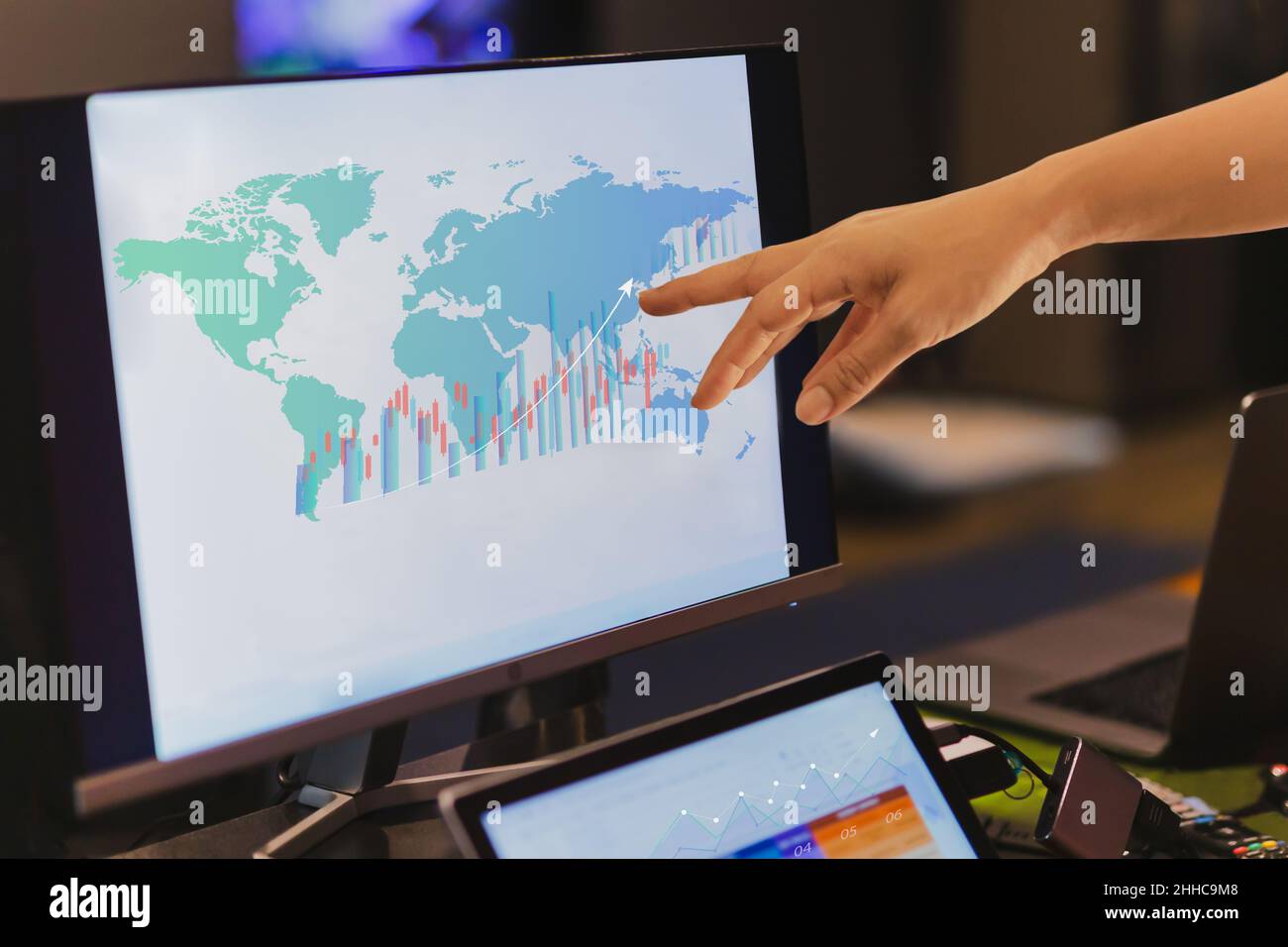Business financial hand pointing on desktop computer screen with ...