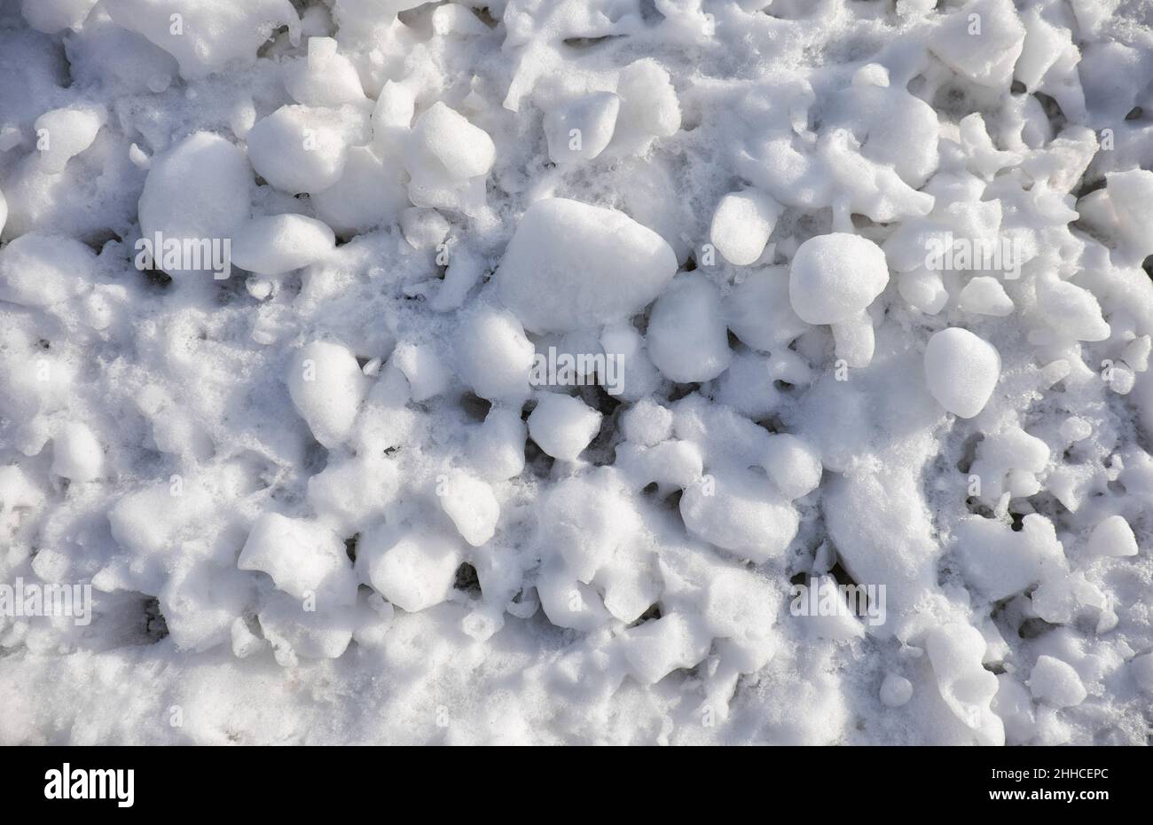 Lumps of snow and ice frazil on the surface of the freezing river water ...