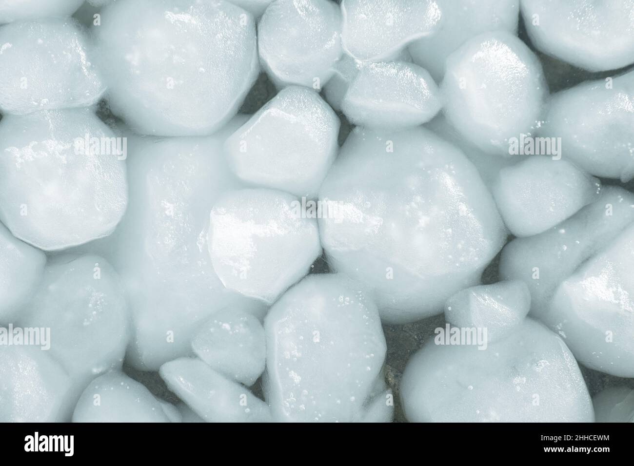 Lumps of snow and ice frazil on the surface of the freezing river water ...