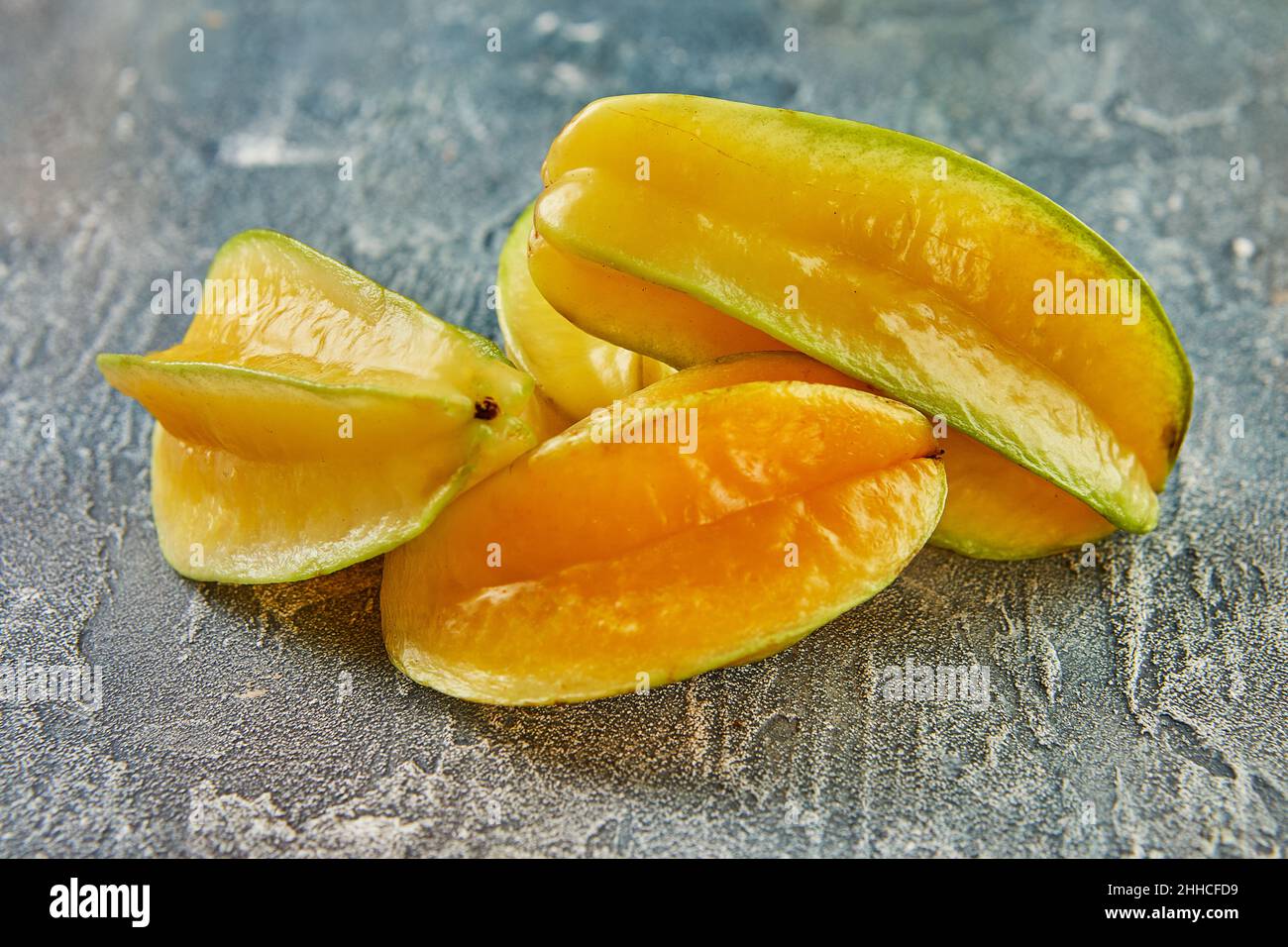 Fresh Averrhoa carambola on blue background. Background of beautiful ...
