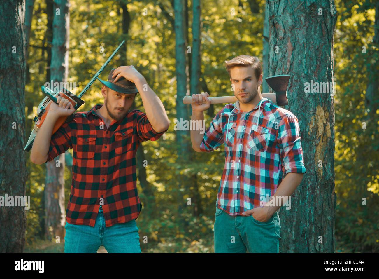 Man woodcutter holding ax. Axe in lumberjack hands cutting wood ...