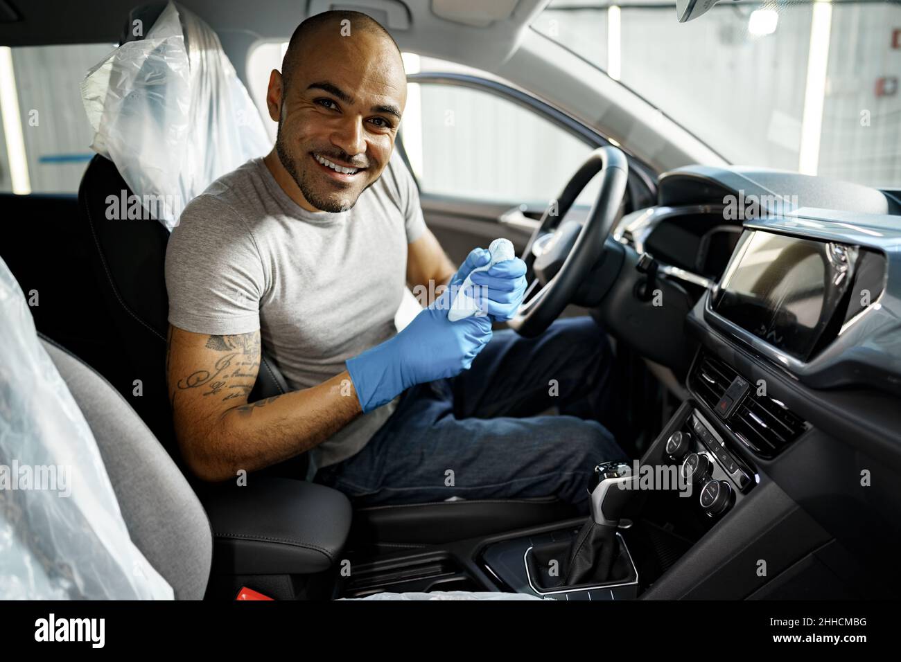 A man cleaning car interior, car detailing in Carwash service Stock ...