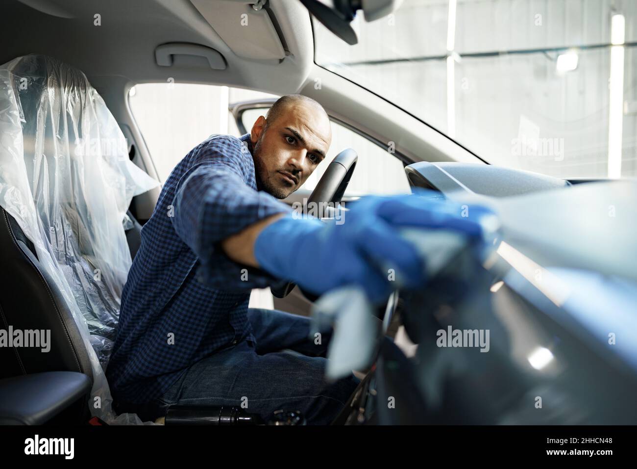 A man cleaning car interior, car detailing in Carwash service Stock ...
