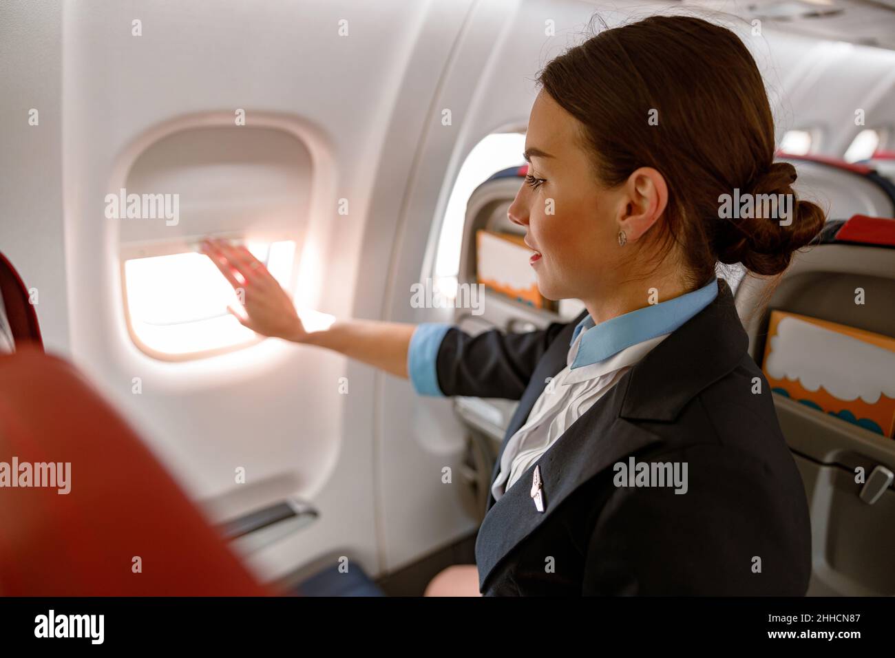 Female flight attendant closing hi-res stock photography and images - Alamy