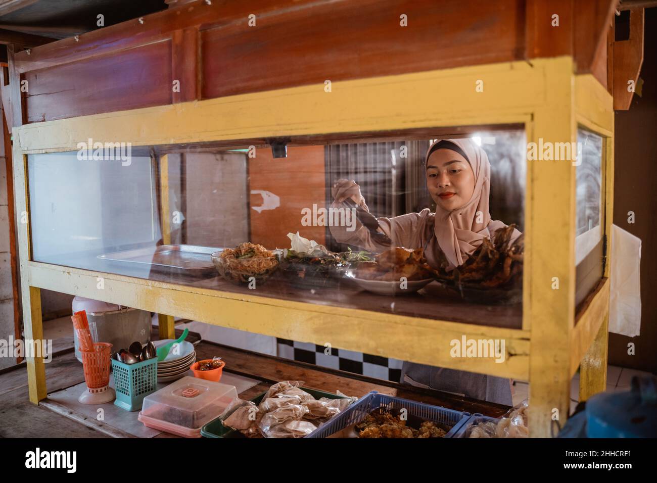 woman with hijab working in her tradtional food shop Stock Photo - Alamy