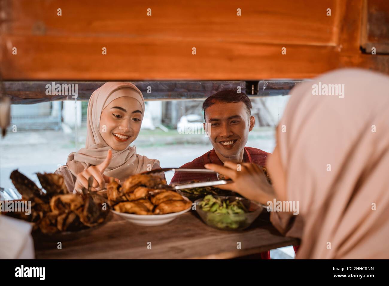 muslim couple ordering food to break fasting in ramadan Stock Photo - Alamy
