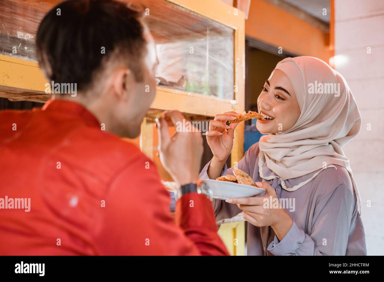 muslim couple sitting on traditional food stall, waiting for iftar time ...