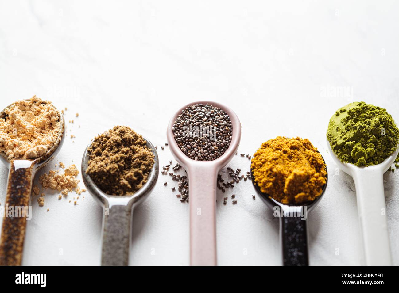 Super food powders in spoons, white marble background, copy space Stock ...