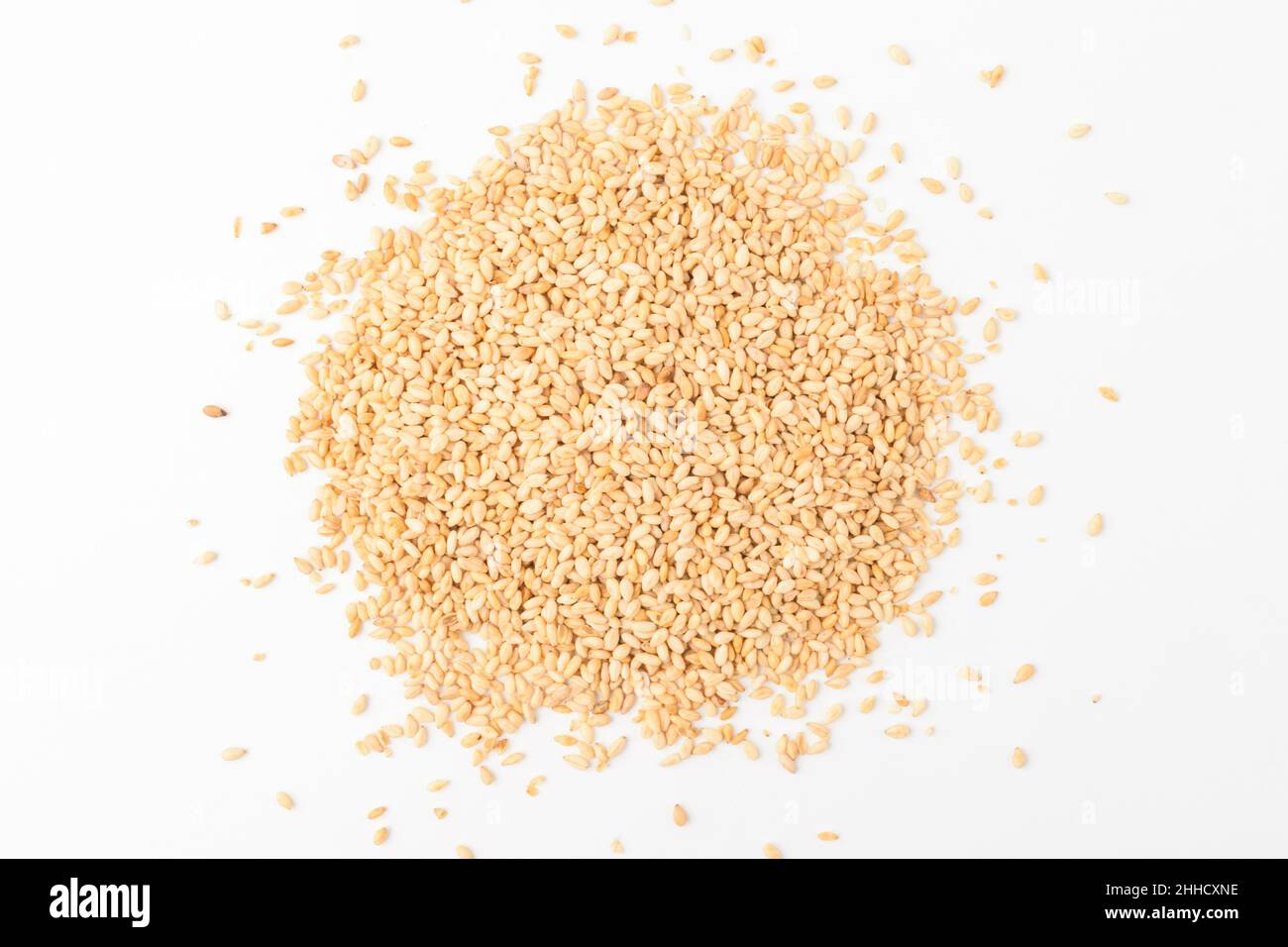Sesame seeds on white background Stock Photo - Alamy