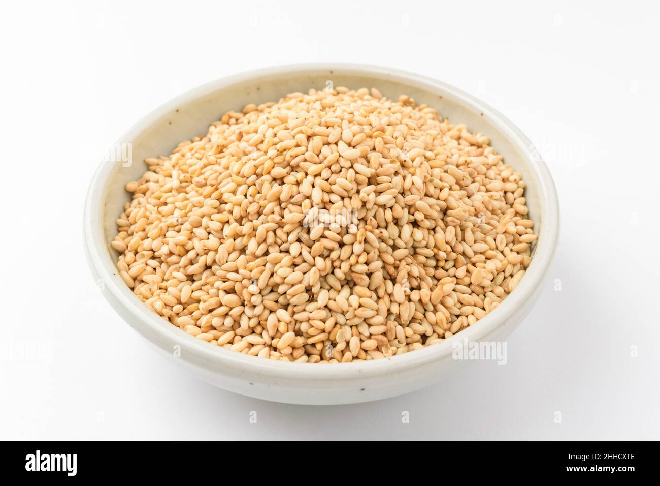 Sesame seeds on white background Stock Photo - Alamy