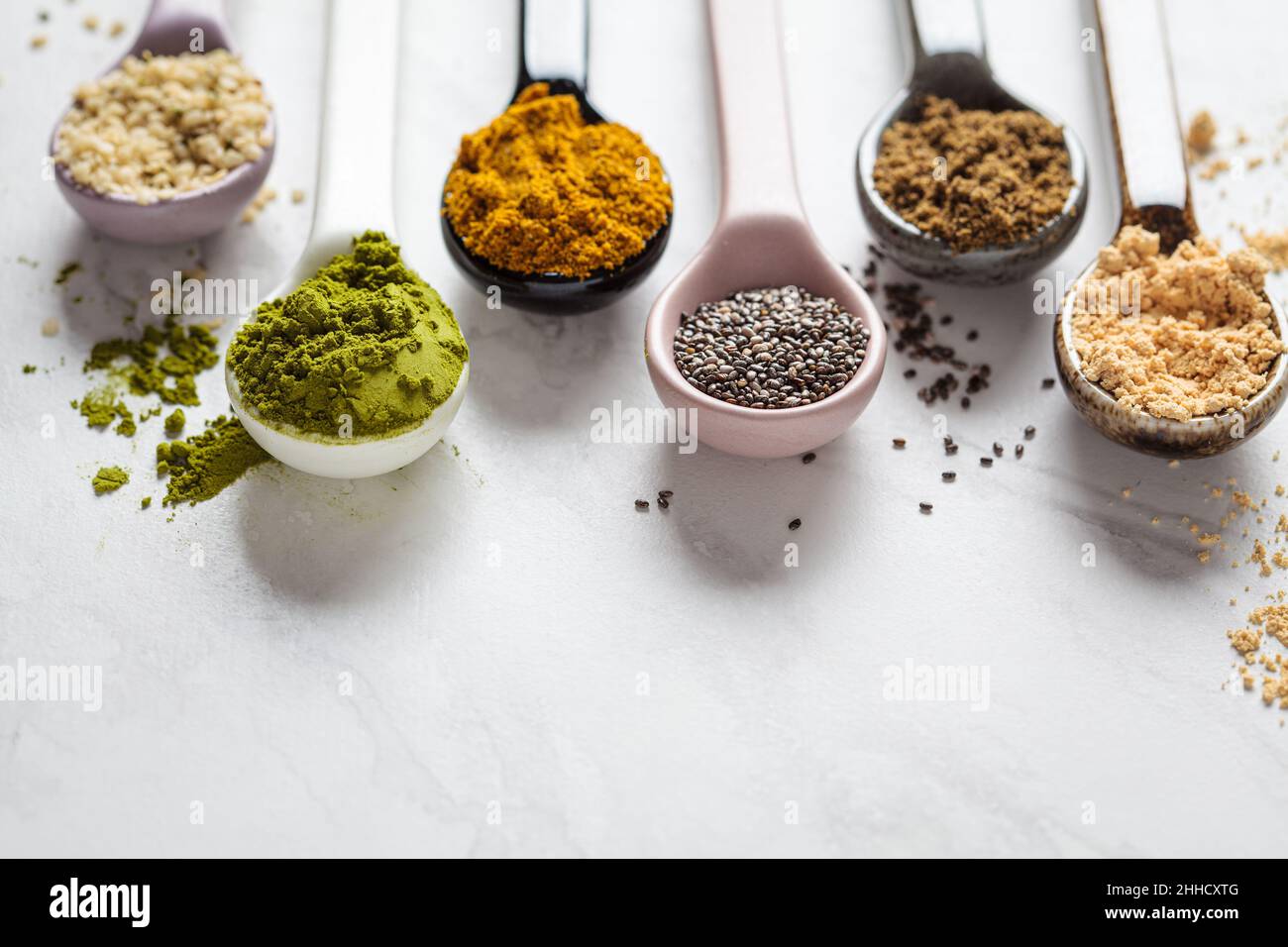 Super food powders in spoons, white marble background, copy space Stock ...