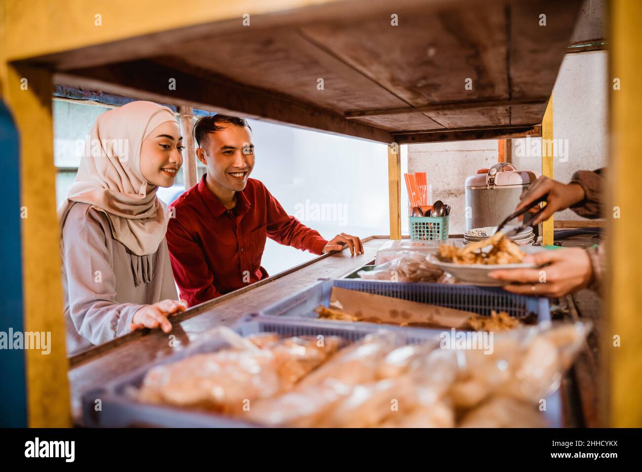 muslim couple sitting on traditional food stall, waiting for iftar time ...