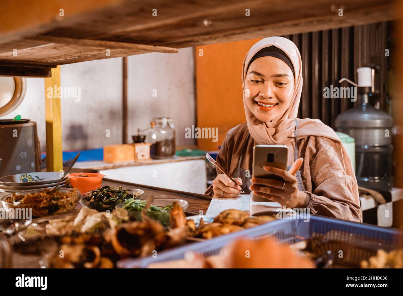 beautiful muslim seller taking order from customer via online Stock ...